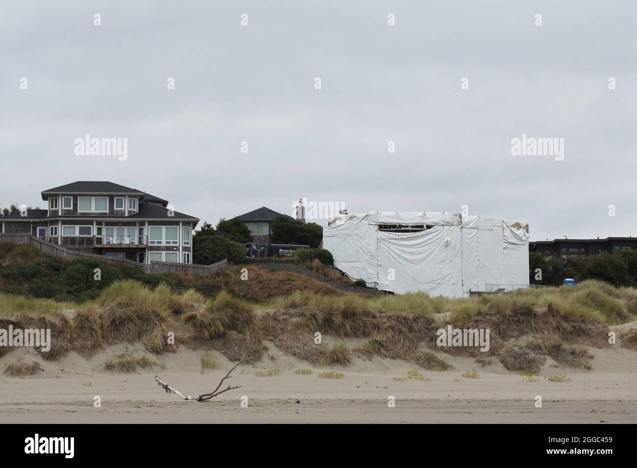 A house covered in white plastic under construction on the coast in ...