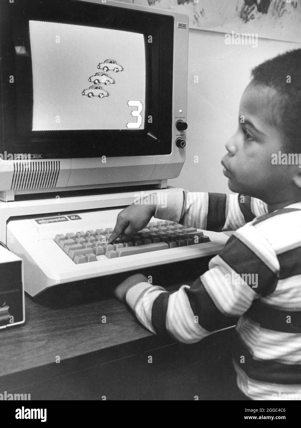 ©1989 Black boy in computer day care center preschool using Apple ...