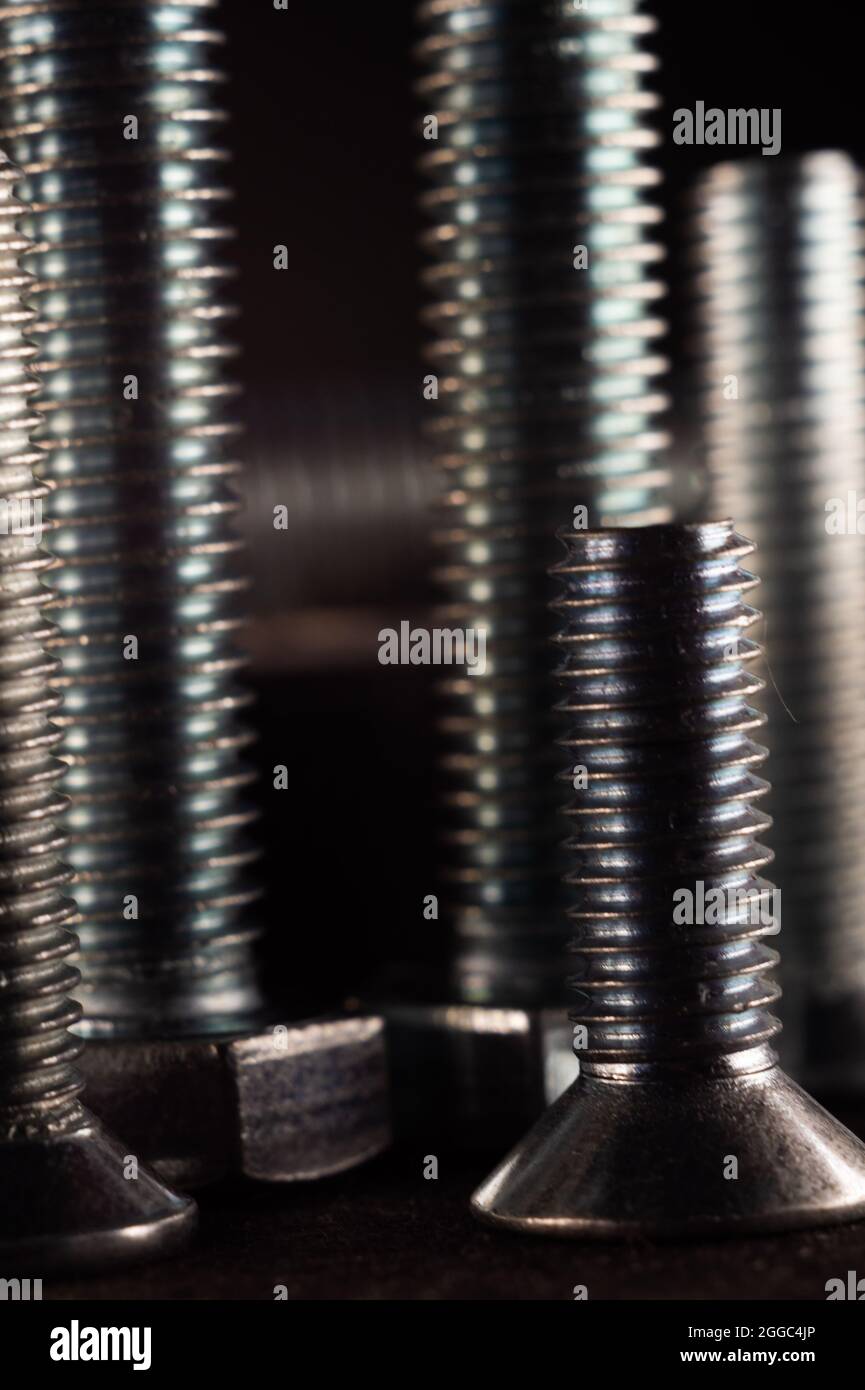 Vertical shot of silver bolts on a dark surface Stock Photo - Alamy