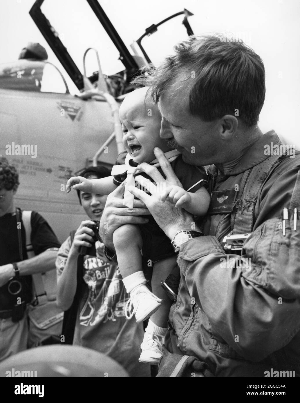 Austin Texas USA, 1991: Baby cries in the arms of father, an Air Force ...