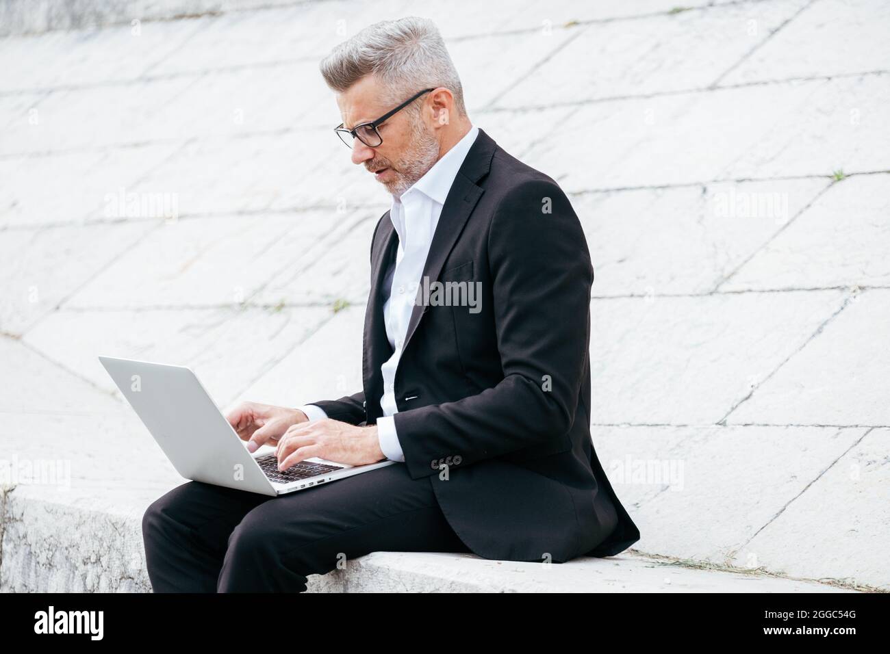 Businessman laptop computer on stairs hi-res stock photography and ...