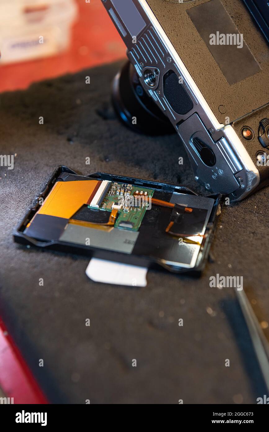 Vertical close-up shot of a printed circuit of a disassembled camera in ...