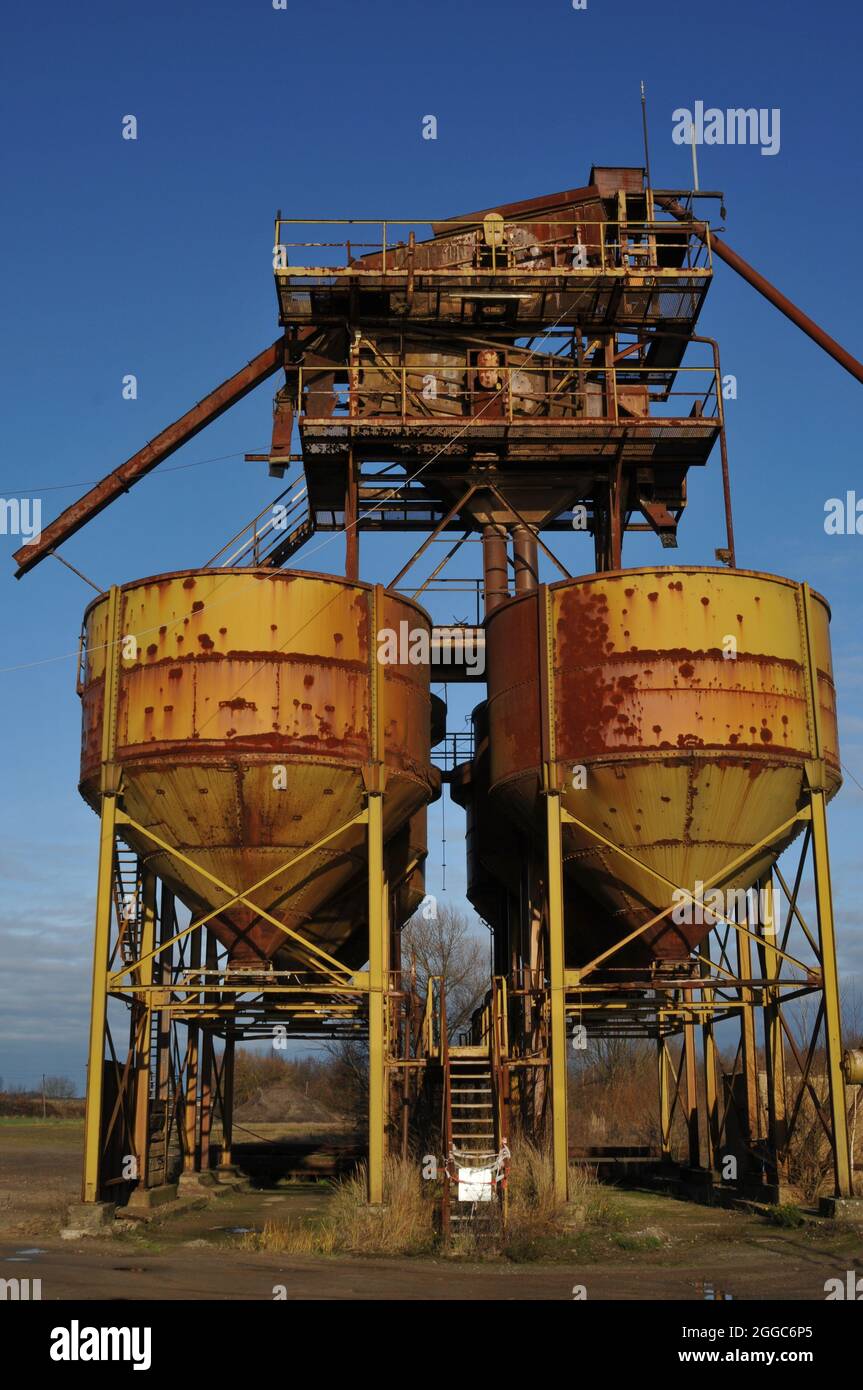 Vertical shot of old rusty silos in a gravel pit Stock Photo - Alamy