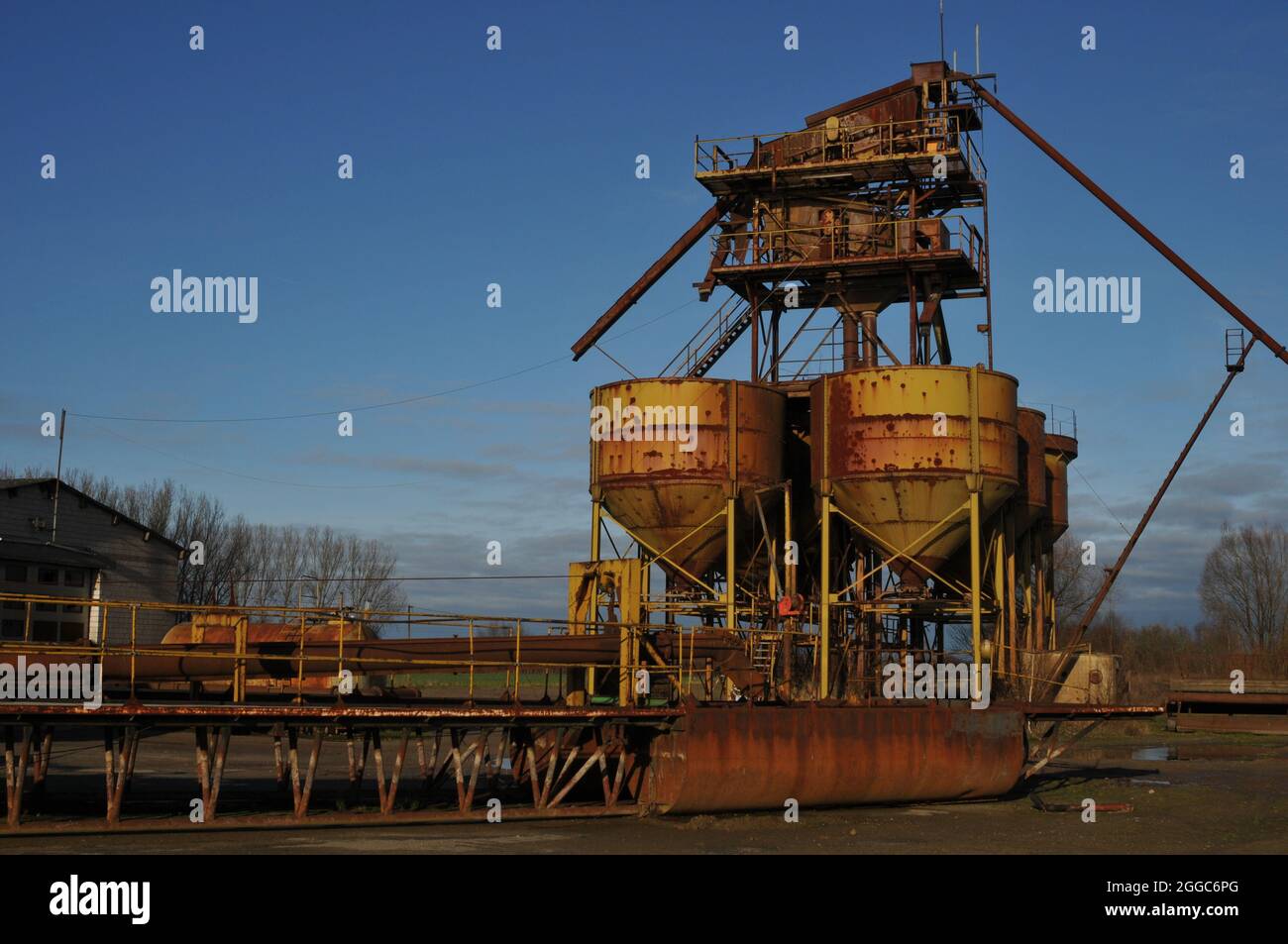 Abandoned industrial site with old rusty silos Stock Photo - Alamy