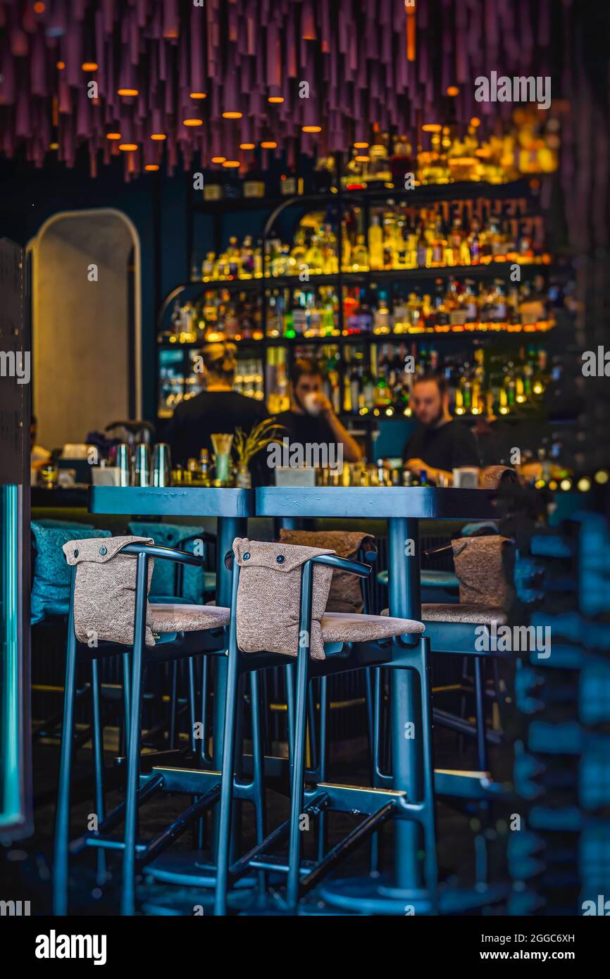 Interior of bar in open window, bright high bar tables chairs, outside ...