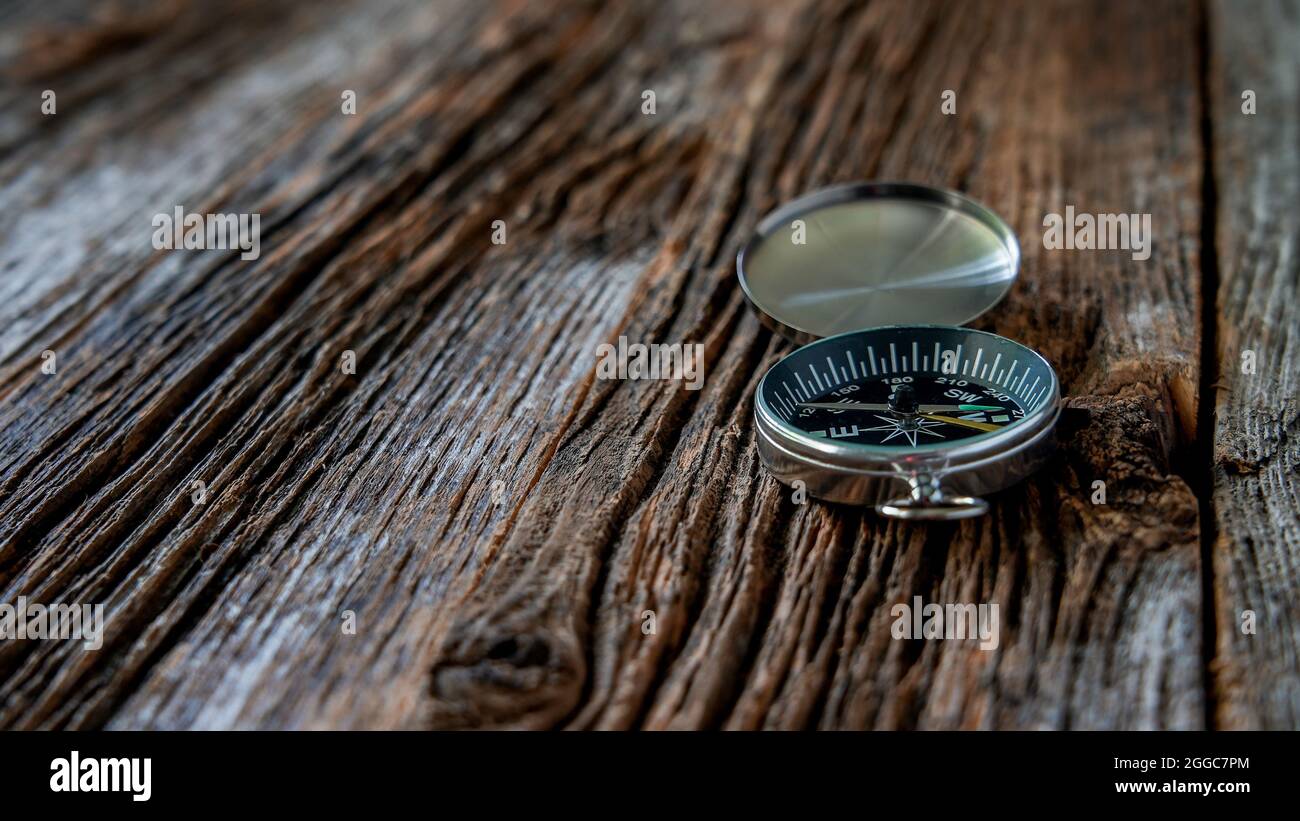Compass on rustic wooden table background Stock Photo - Alamy