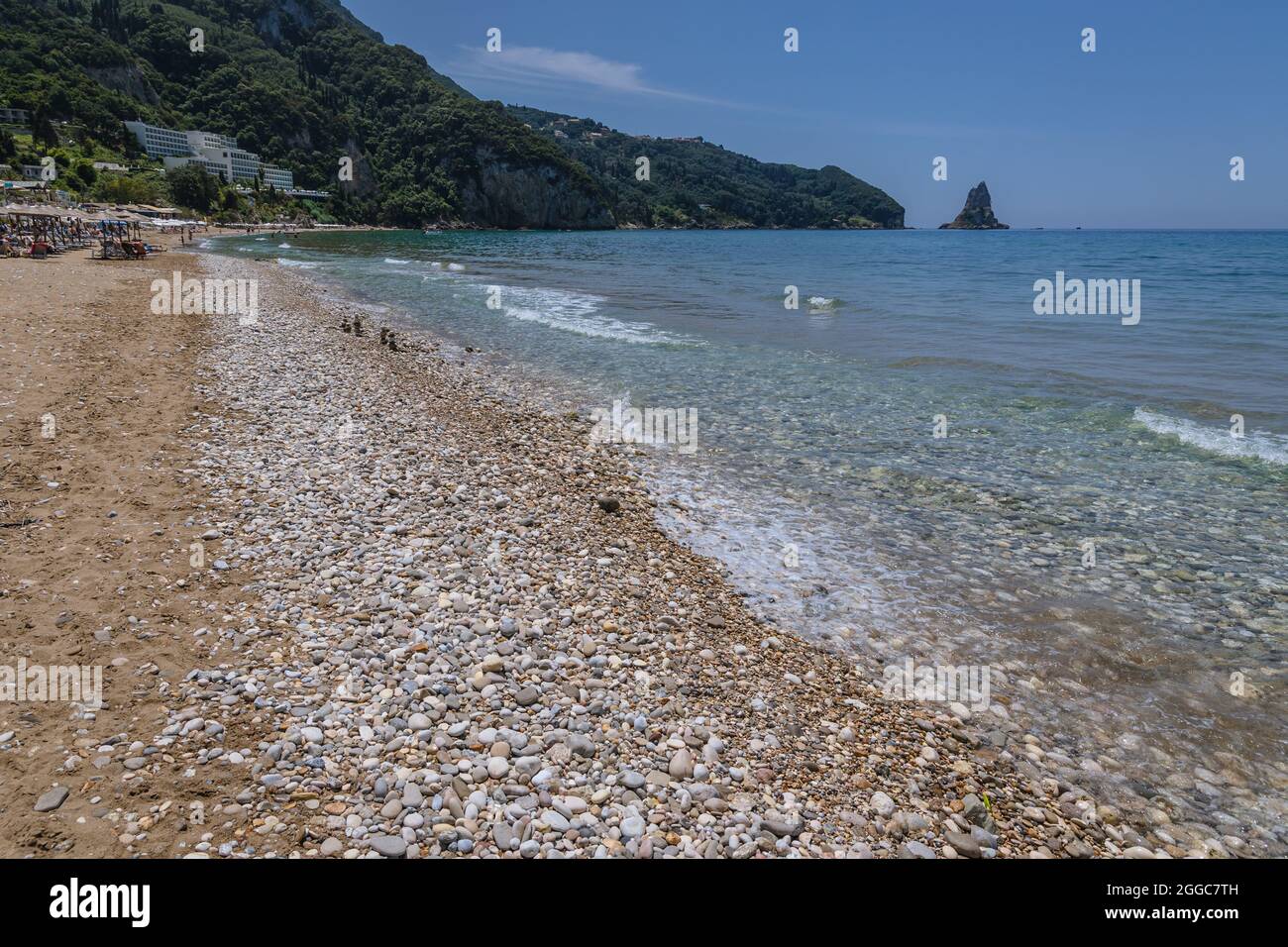 Ionian Sea beach in Agios Gordios town on a Greek Island of Corfu, view with Ortholithi rock on ...