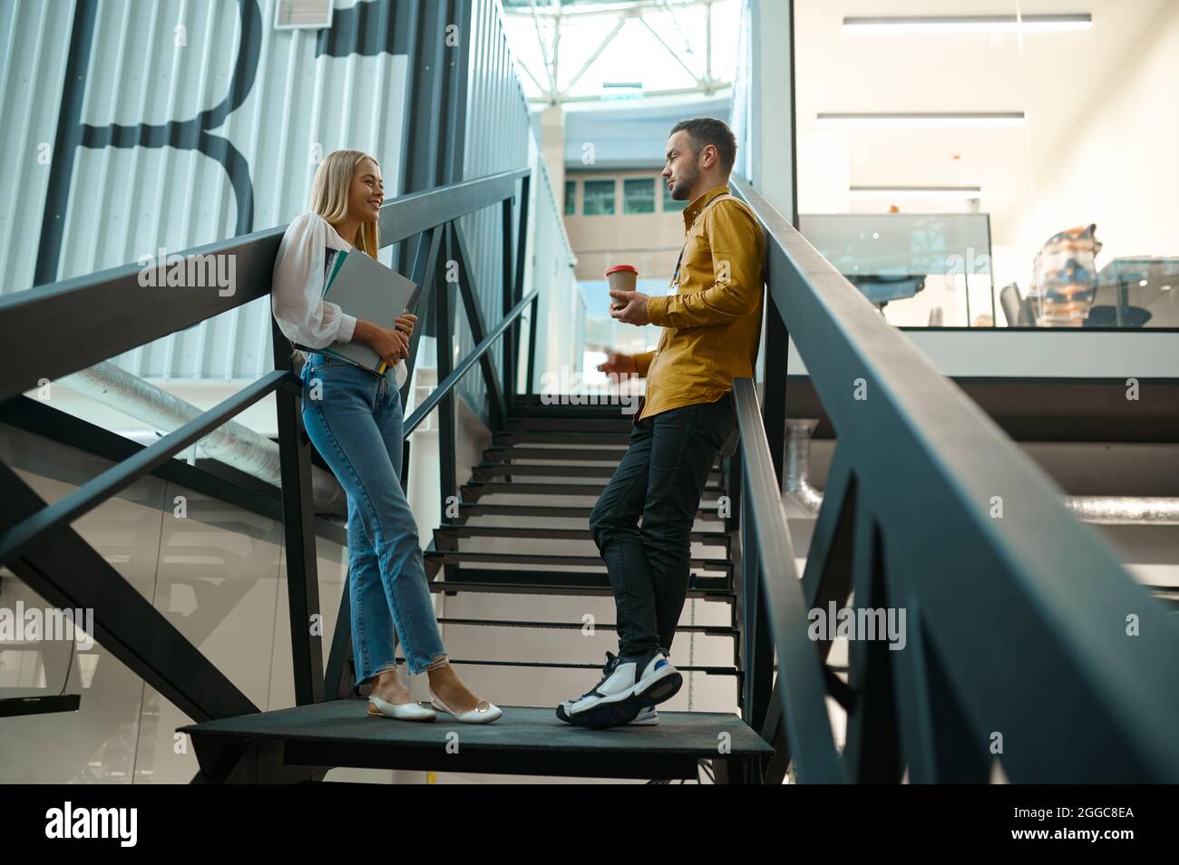 Two managers talks on stairs in IT office Stock Photo - Alamy