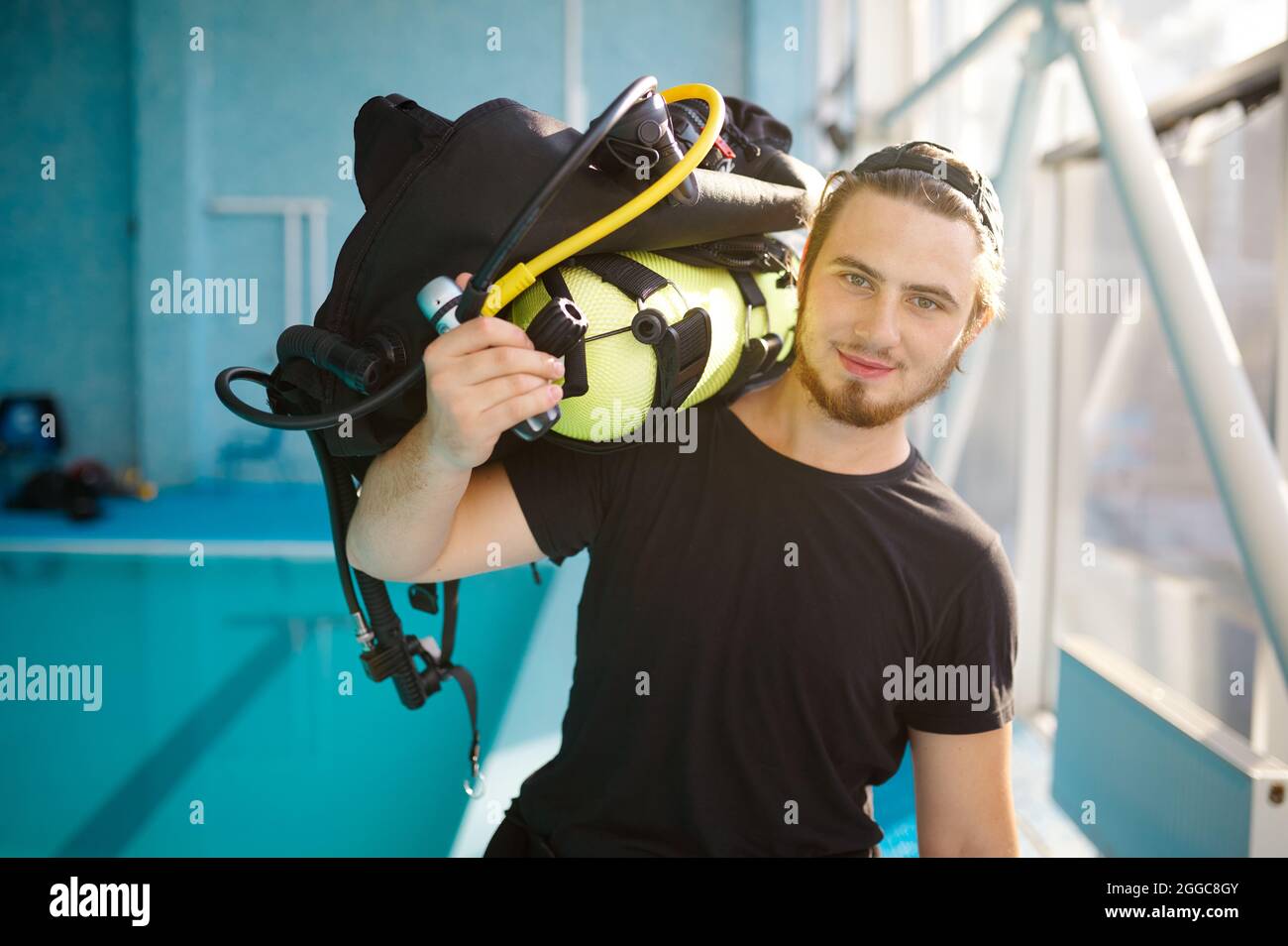 Male diver holds scuba gear, diving school Stock Photo - Alamy