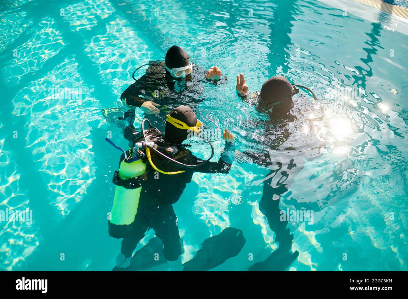 Divemaster and divers in aqualungs, diving school Stock Photo - Alamy