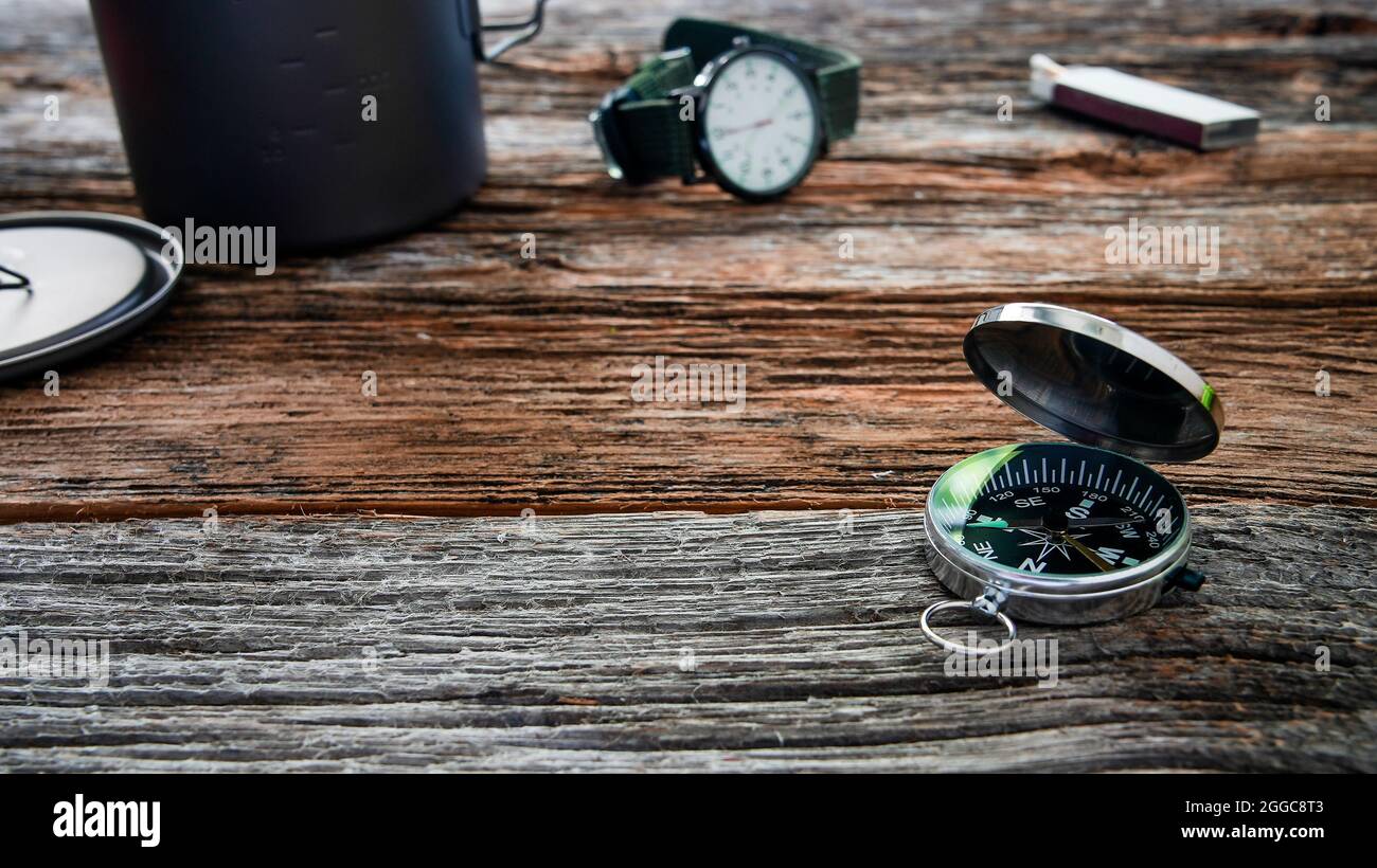 Compass with other objects on rustic wooden table background Stock ...