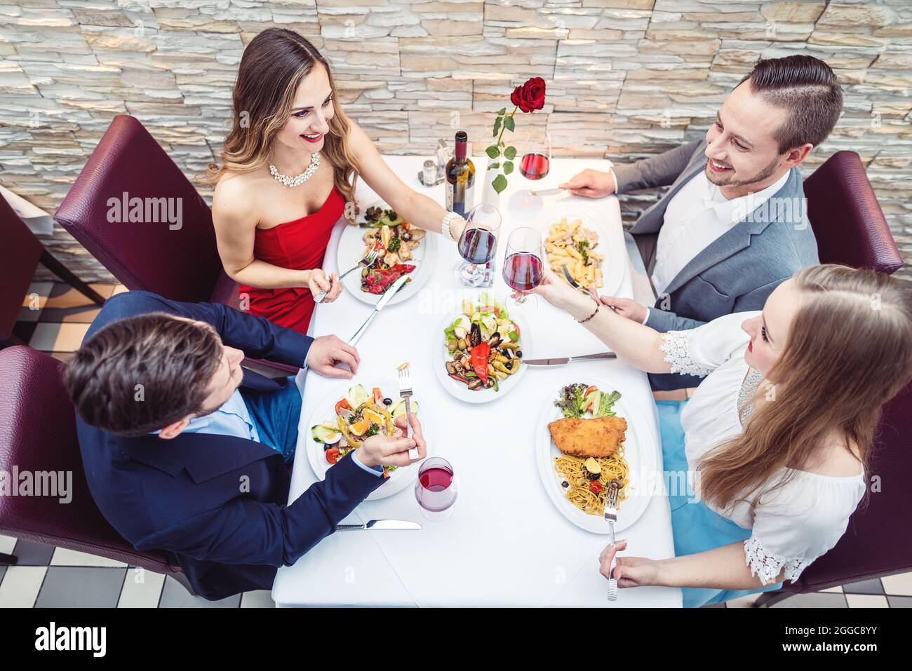 Friends enjoying atmosphere, food, and drink in fancy restaurant Stock ...