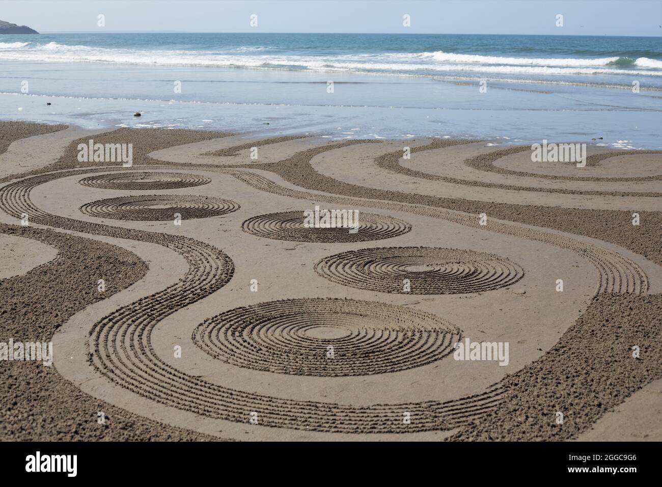 The rising tide erases a sand labyrinth in Bandon, Oregon, USA Stock ...