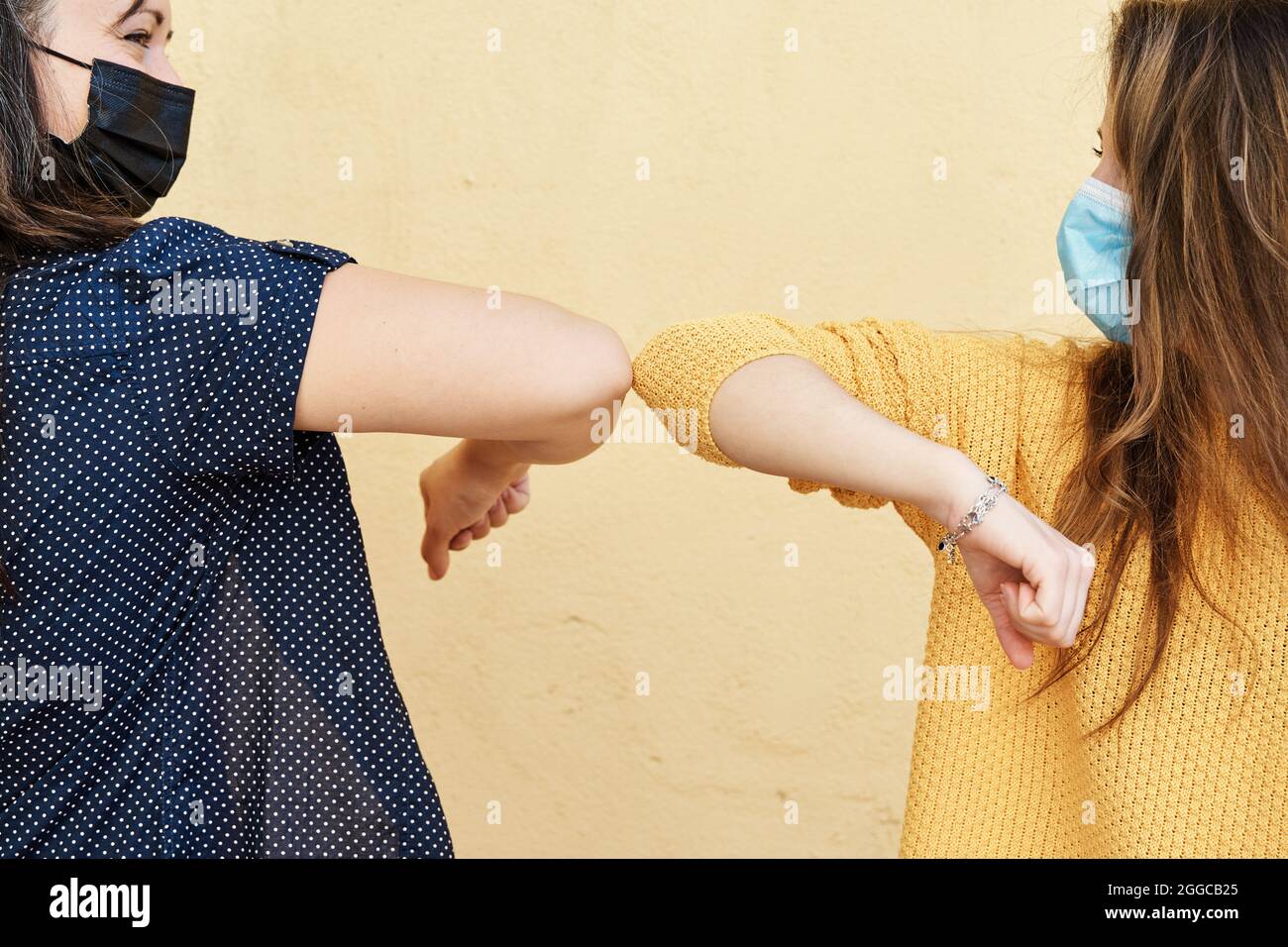Close-up of an elbow bump, a new and safe way of greeting, alternative ...