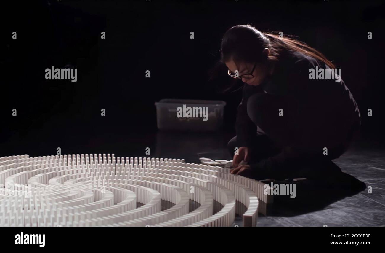LILY TOPPLES THE WORLD, Lily Hevesh working on a domino artwork, 2021 ...