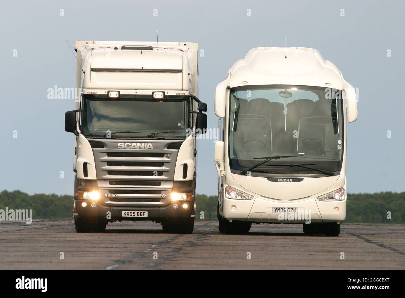 HGV truck passing a coach on a wet test track Stock Photo - Alamy