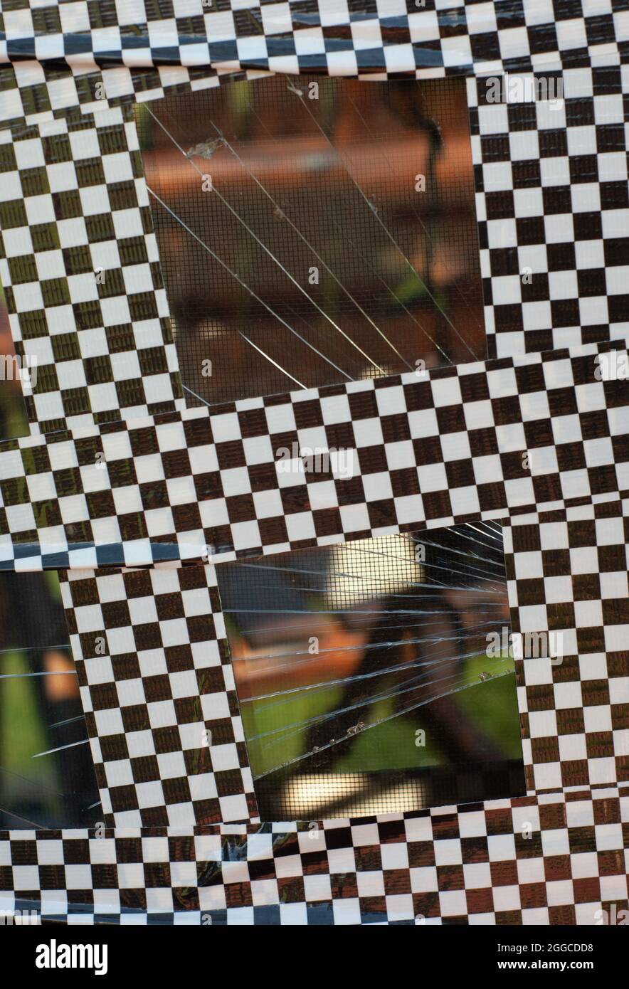 Black and white checkered tape holding broken glass together until it ...