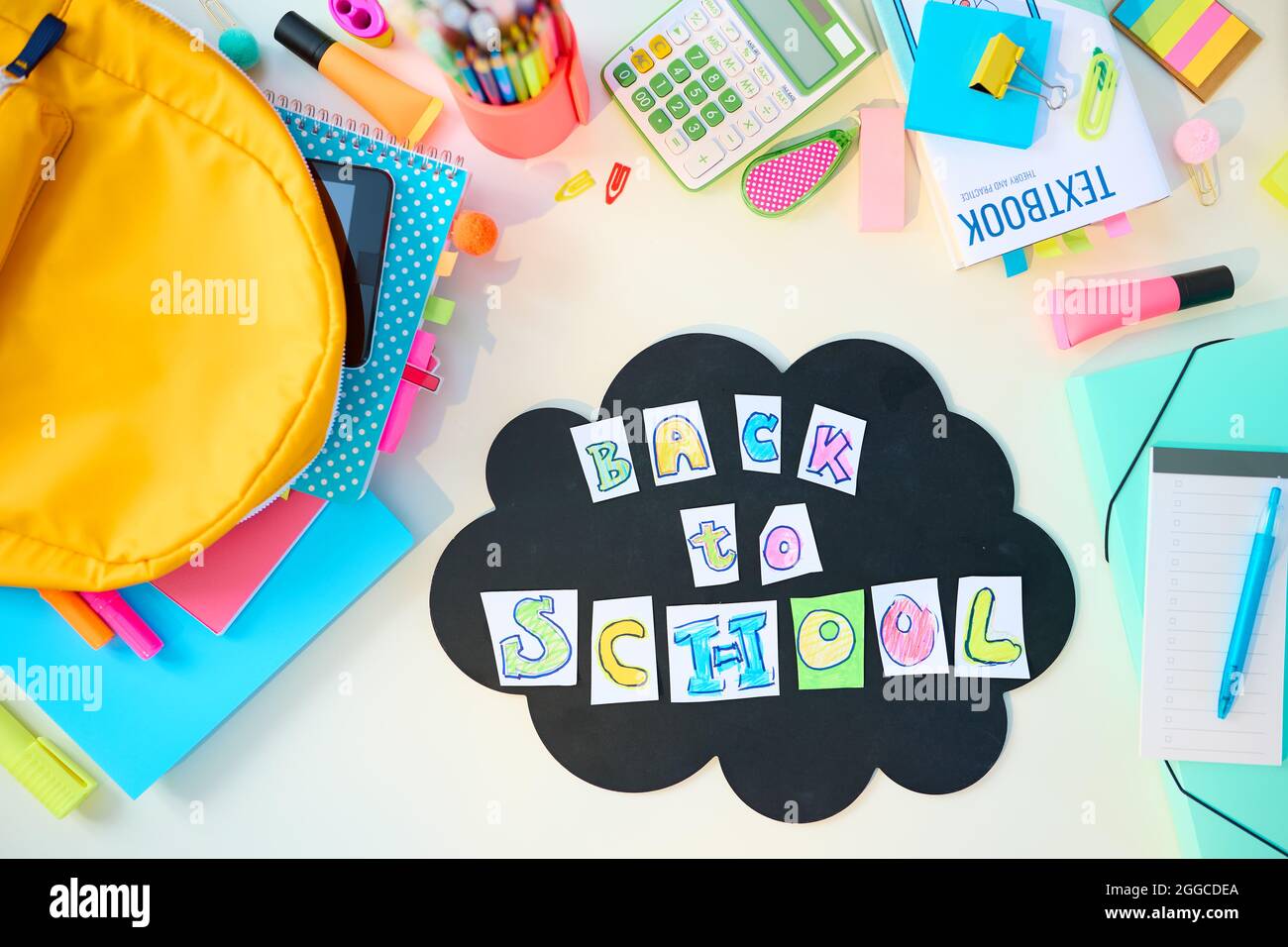 Back to school. Upper view of white desk with workbooks, stationary ...