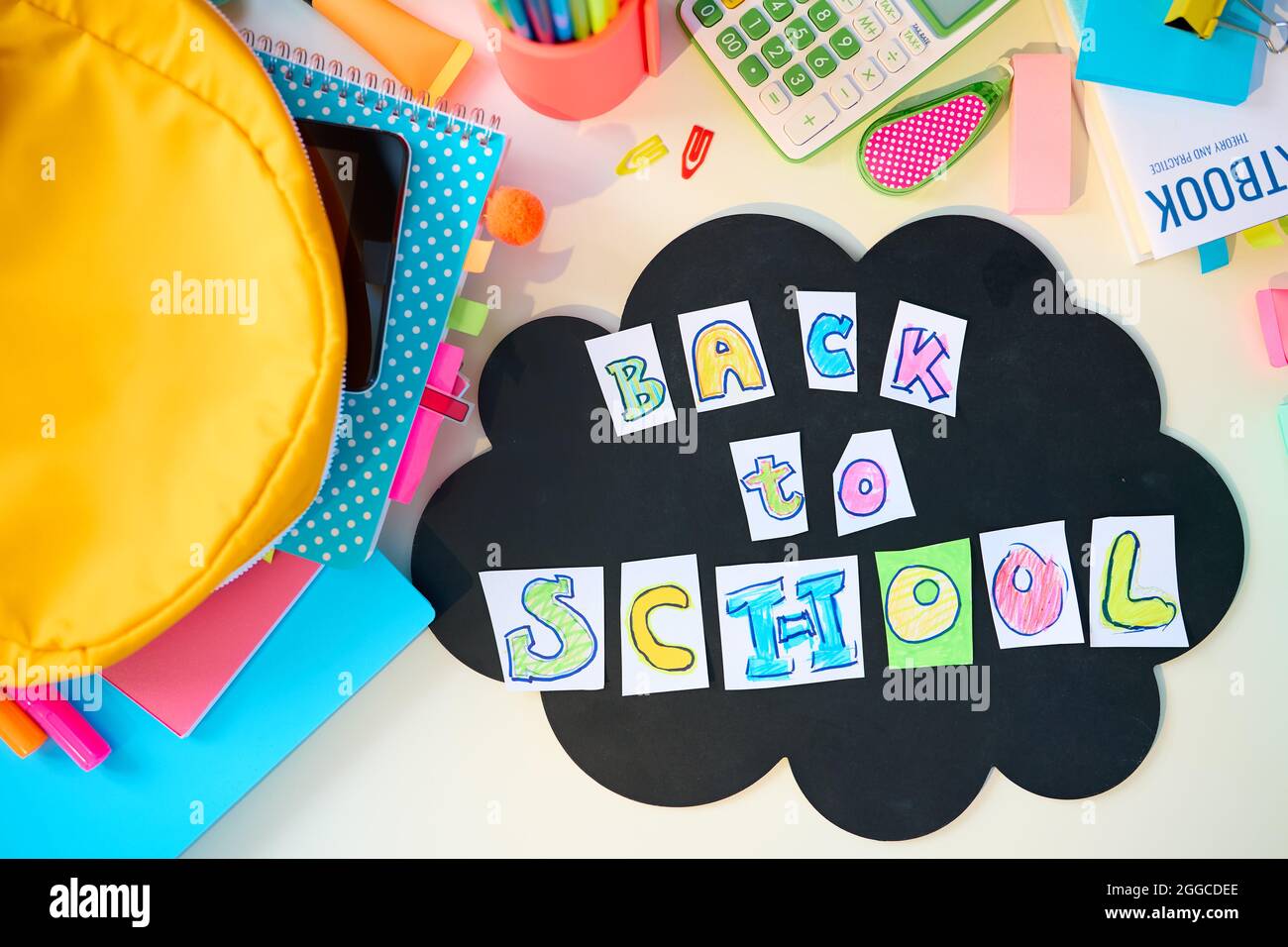 Back to school. Upper view of white desk with workbooks, stationary ...