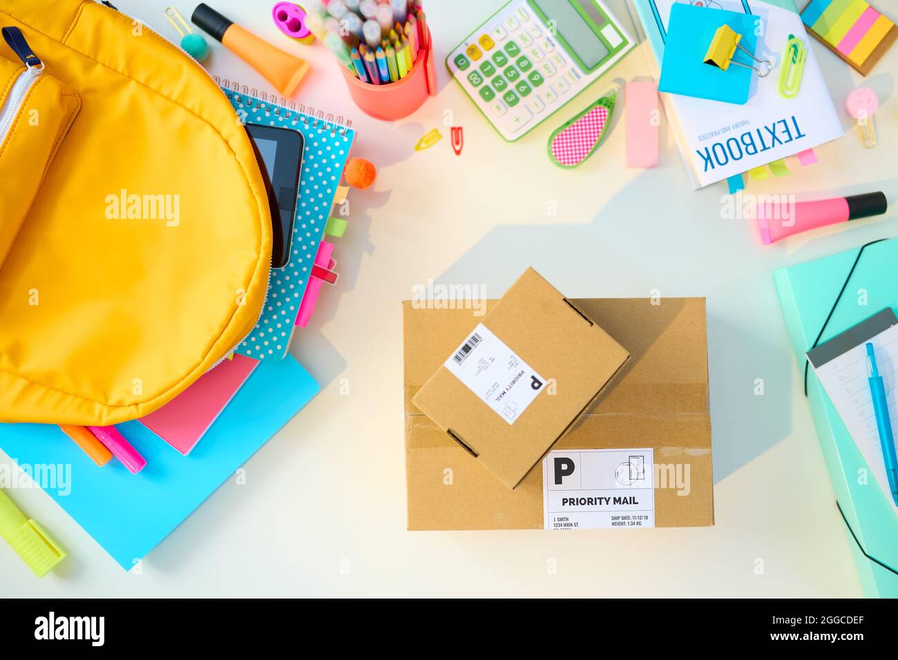 Back to school. Upper view of white table with workbooks, stationary ...