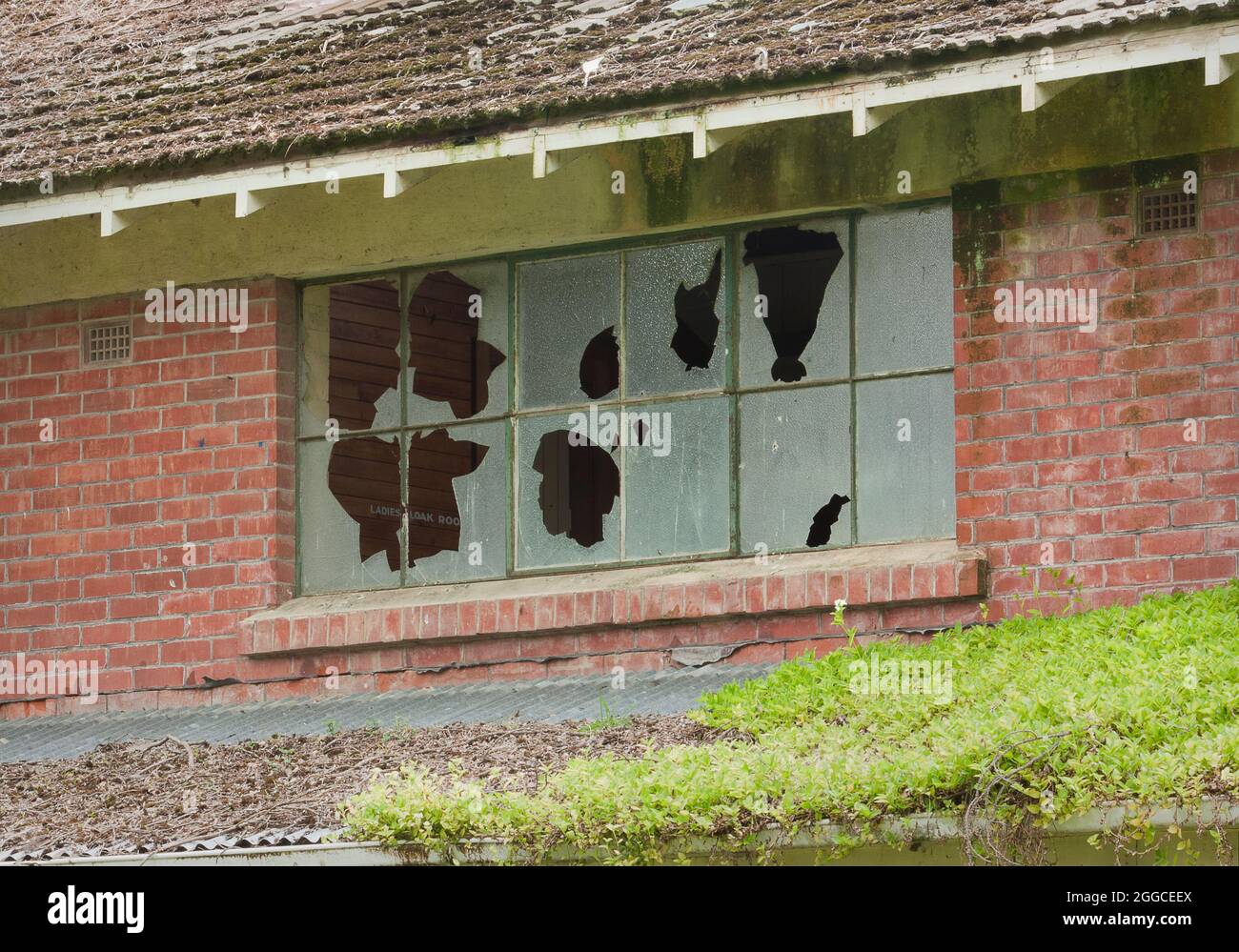 Broken windows in an old abandoned brick building Stock Photo - Alamy