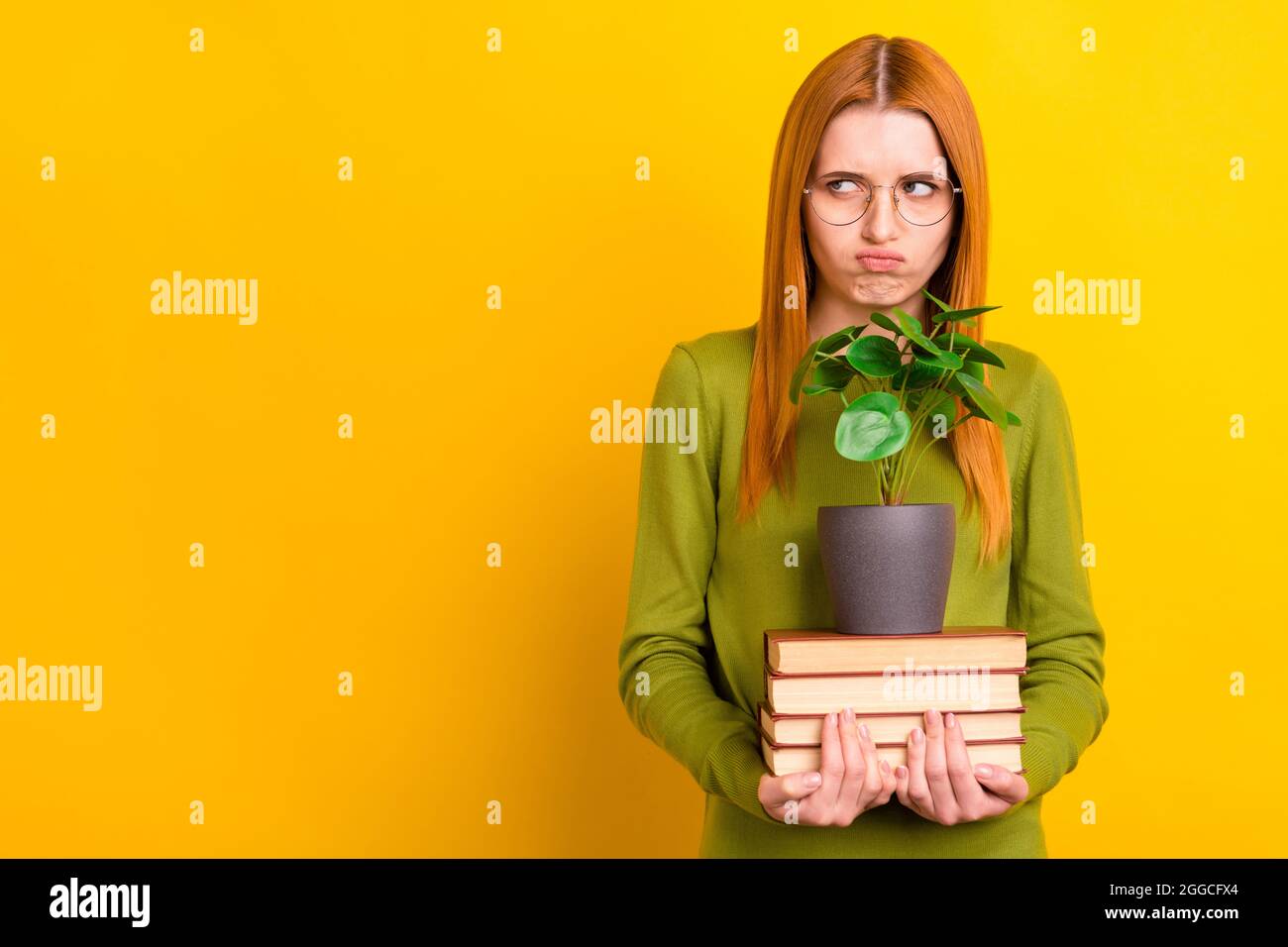Photo of sad red hairdo millennial lady hold book plant look empty ...