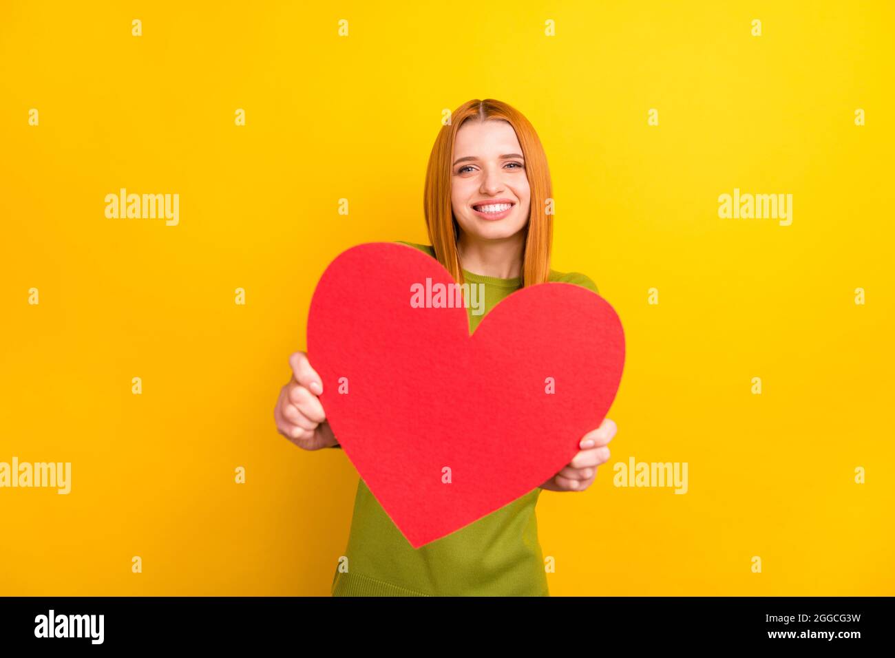 Photo of romantic red hair young lady hold heart wear green sweater ...