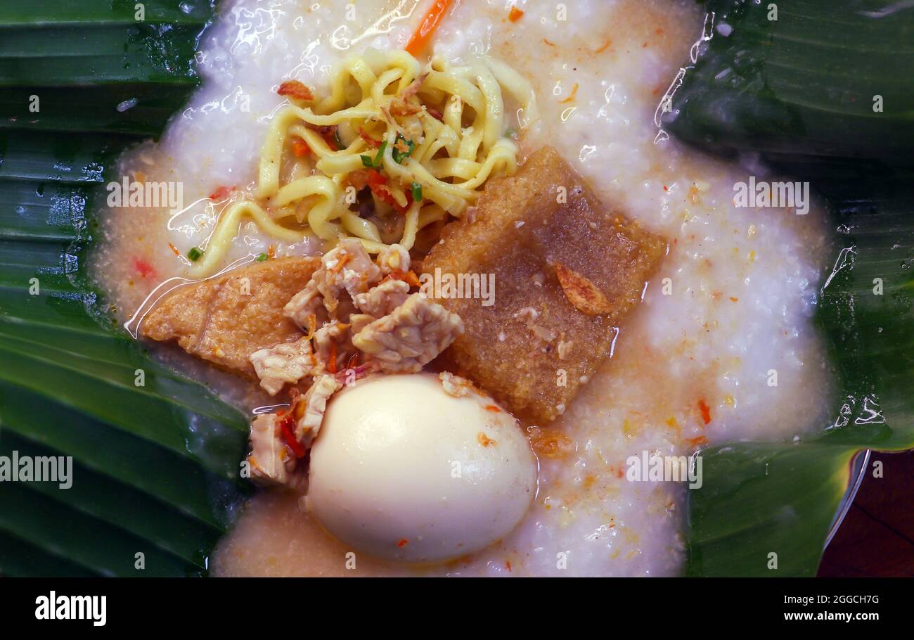 Bubur Jawa, Indonesian rice porridge with egg and yellow noodles, in ...