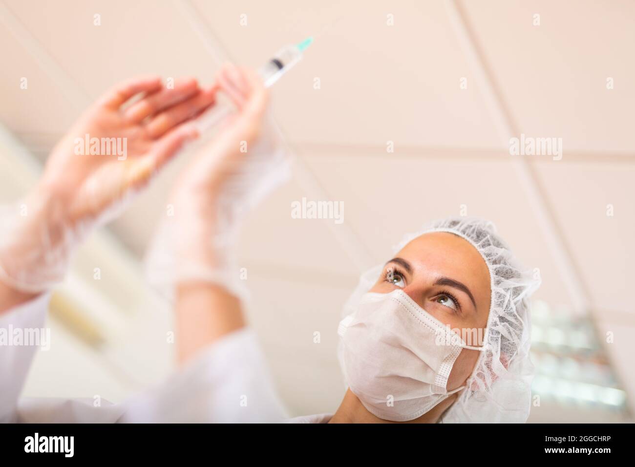 Nurse prepares a syringe for injection Stock Photo - Alamy