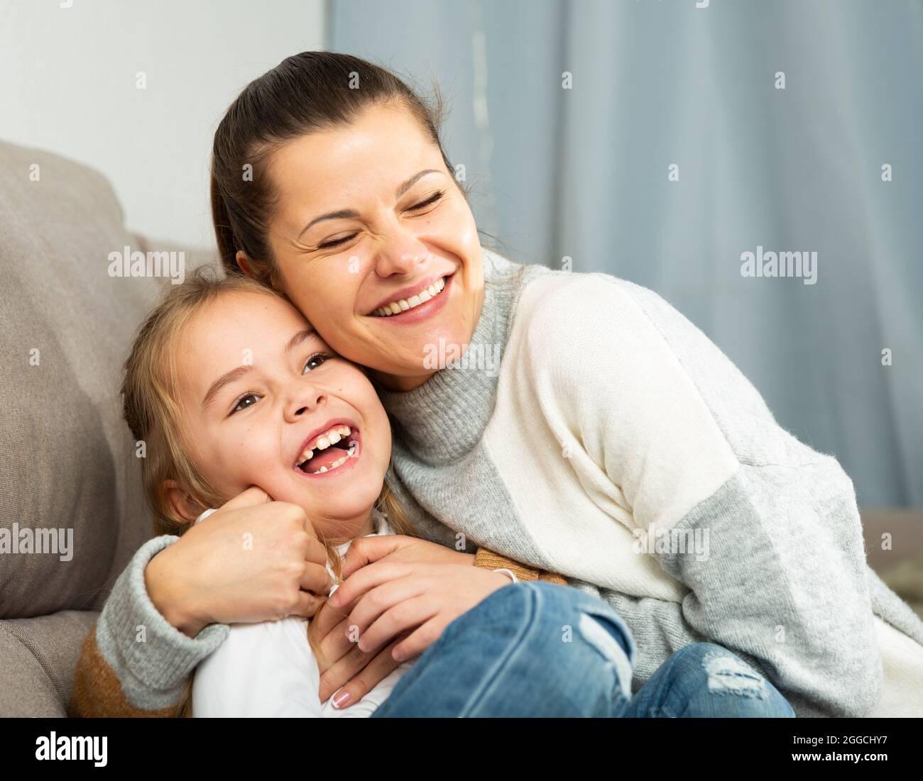 Happy family woman with small daughter laughing at home Stock Photo - Alamy