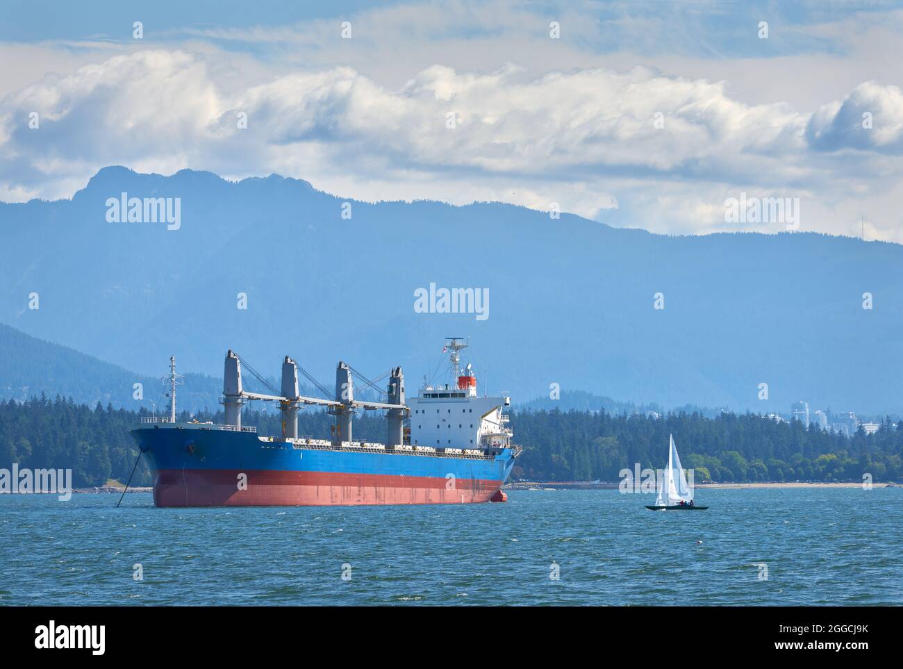 English Bay Freighter at Anchor. An anchored freighter and sailboat in ...