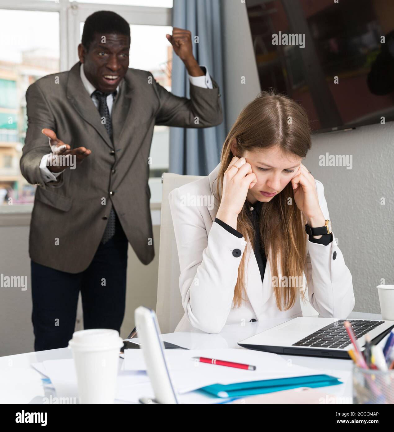 Upset woman with angry boss Stock Photo - Alamy