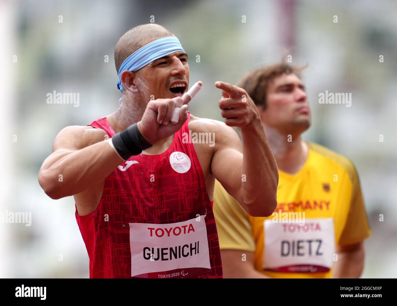 Tunisia's Yassine Guenichi (left) reacts in the Men's Shot Put F36 ...