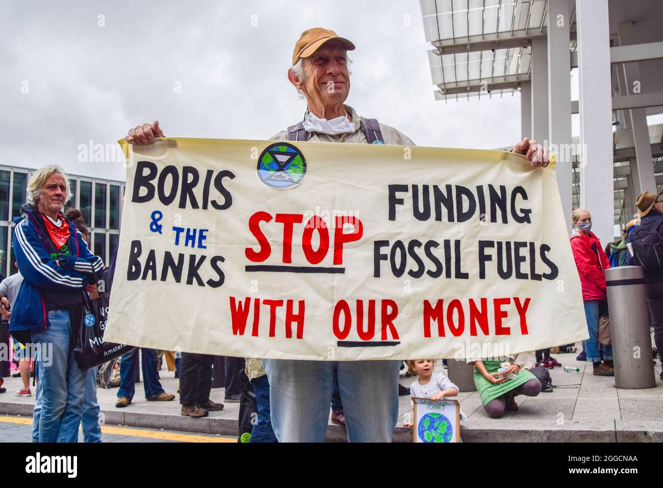 London, UK. 30th Aug, 2021. A protester holds a banner calling on Boris ...