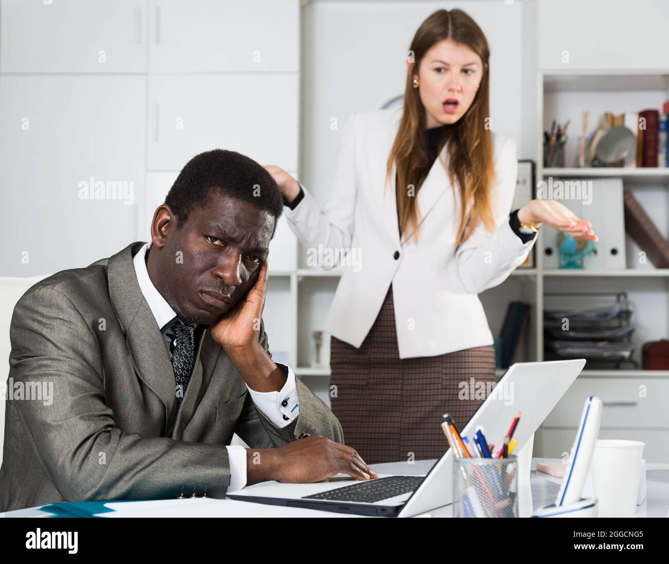 Angry female boss screaming to young male manager during working Stock ...