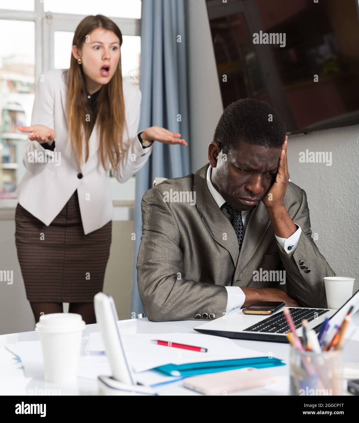 Upset man with angry boss Stock Photo - Alamy