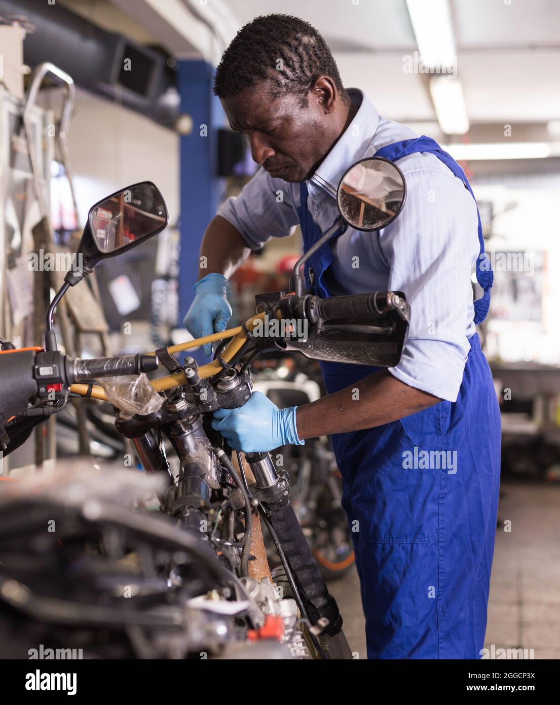 Service engineer repairing motorcycle in motorcycle service Stock Photo ...