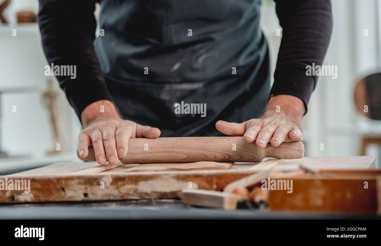 Man forming mold from pottery clay at workshop Stock Photo - Alamy