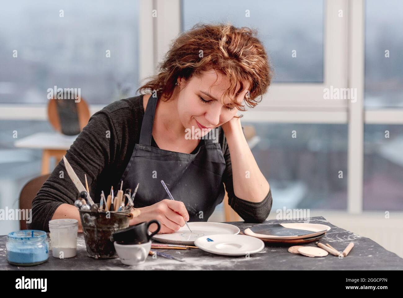 Woman decorating plate handmade hi-res stock photography and images - Alamy