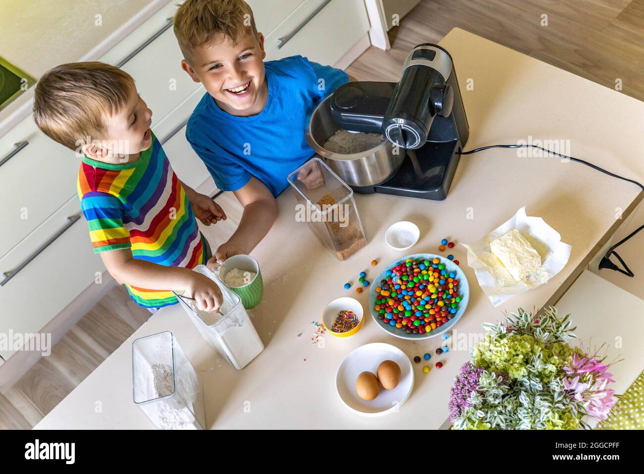 Top view baby brothers kids cooking dessert together use fresh healthy ...