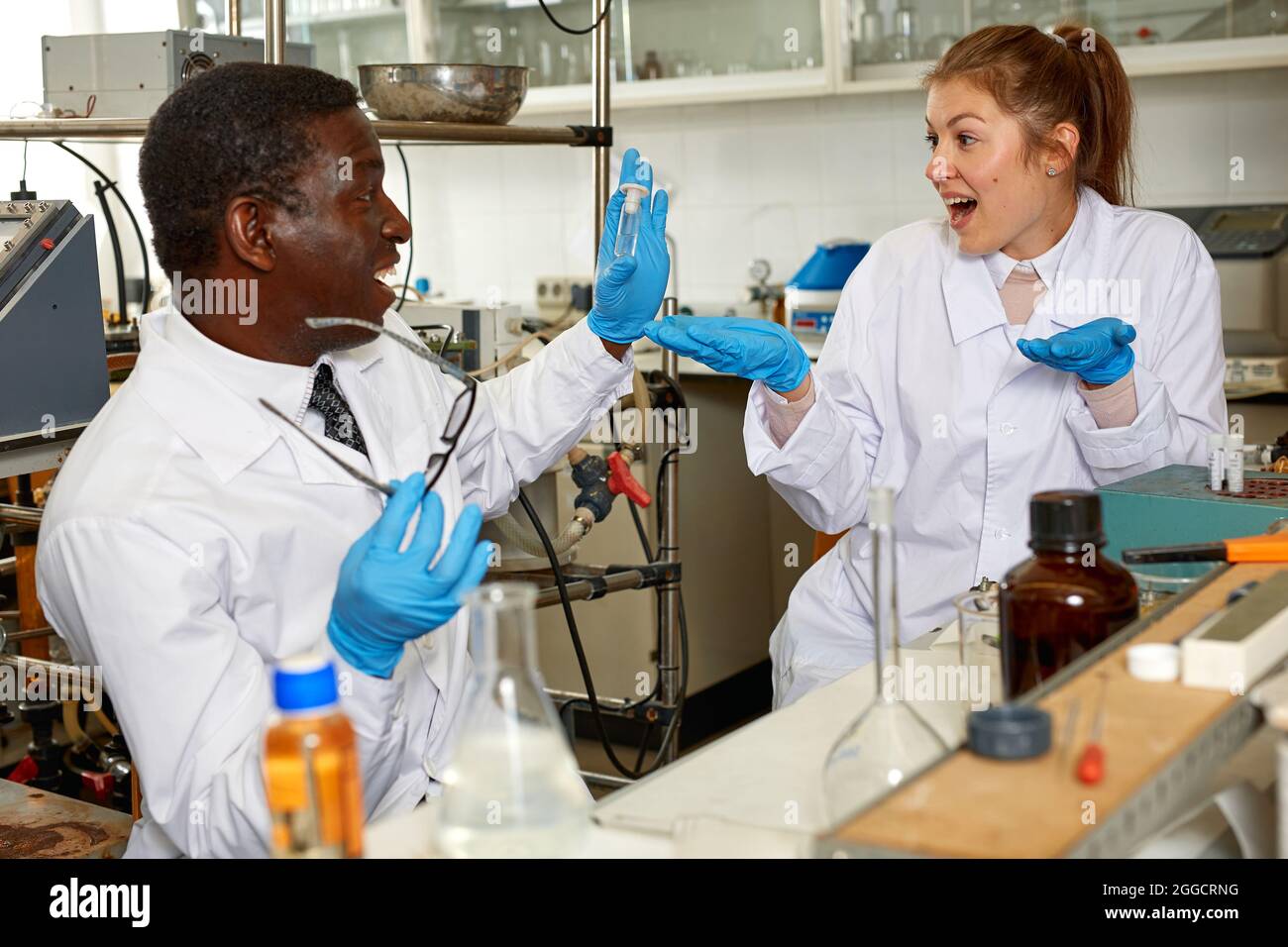 Emotional lab technicians woman and man happy with result of experiment ...