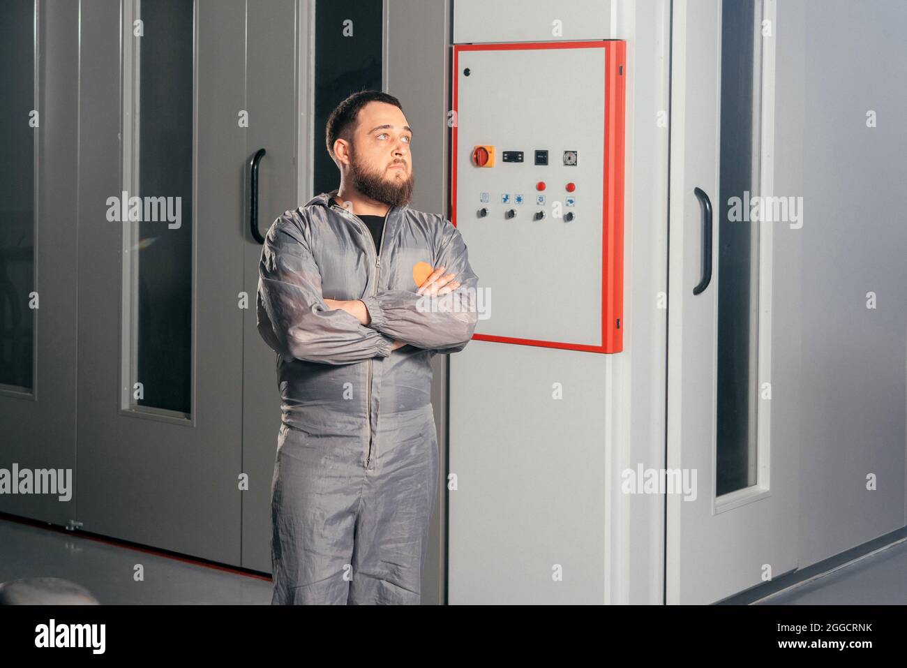 auto mechanic worker operating painting camera in a car repair station ...