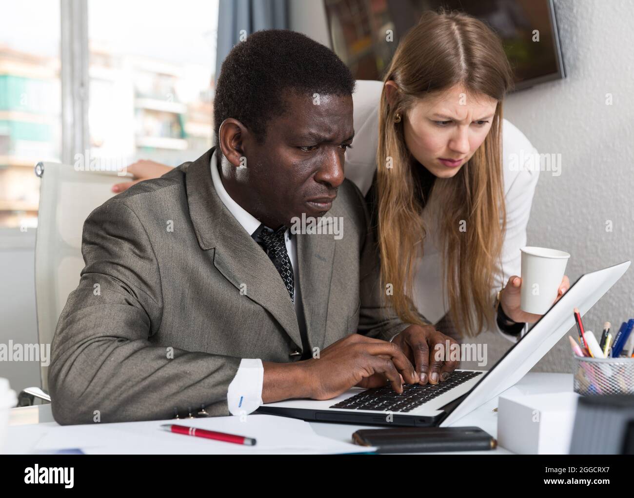 Focused coworkers working together Stock Photo - Alamy