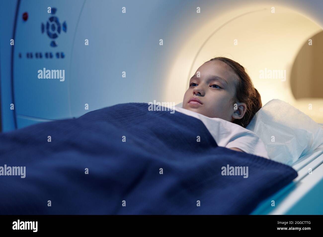 Calm little girl going to undergo mri scan examination while moving ...