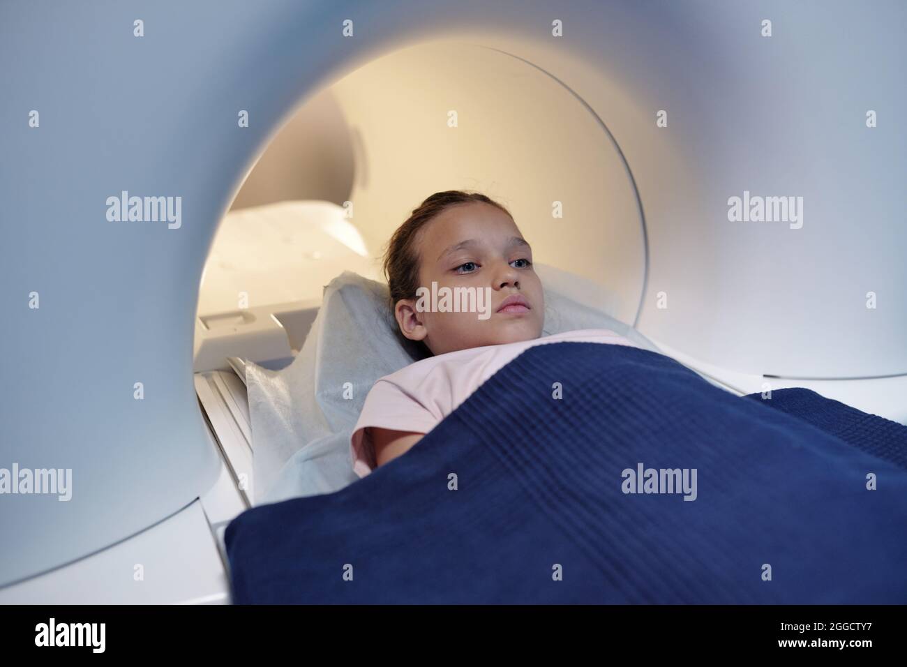 Cute child covered with blue towel going to undergo medical examination ...