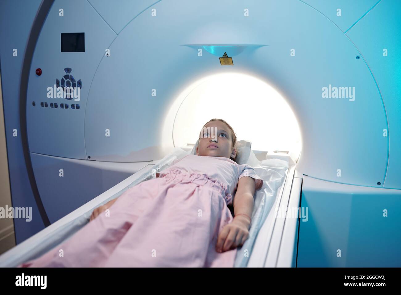 Calm little patient moving into mri scan machine for medical ...