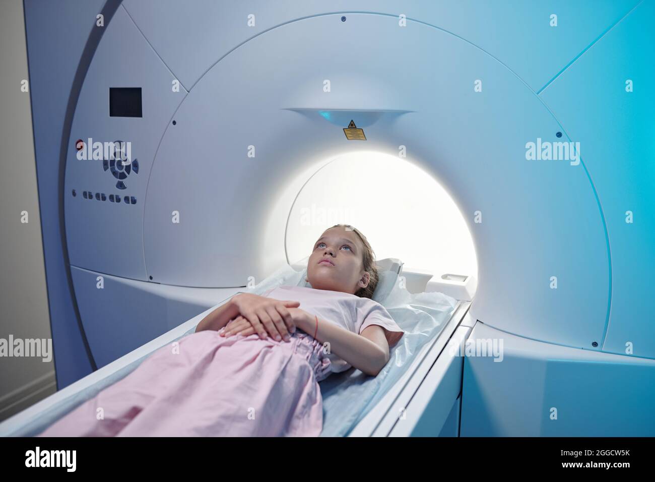 Little patient of clinics undergoing mri scan examination while moving ...