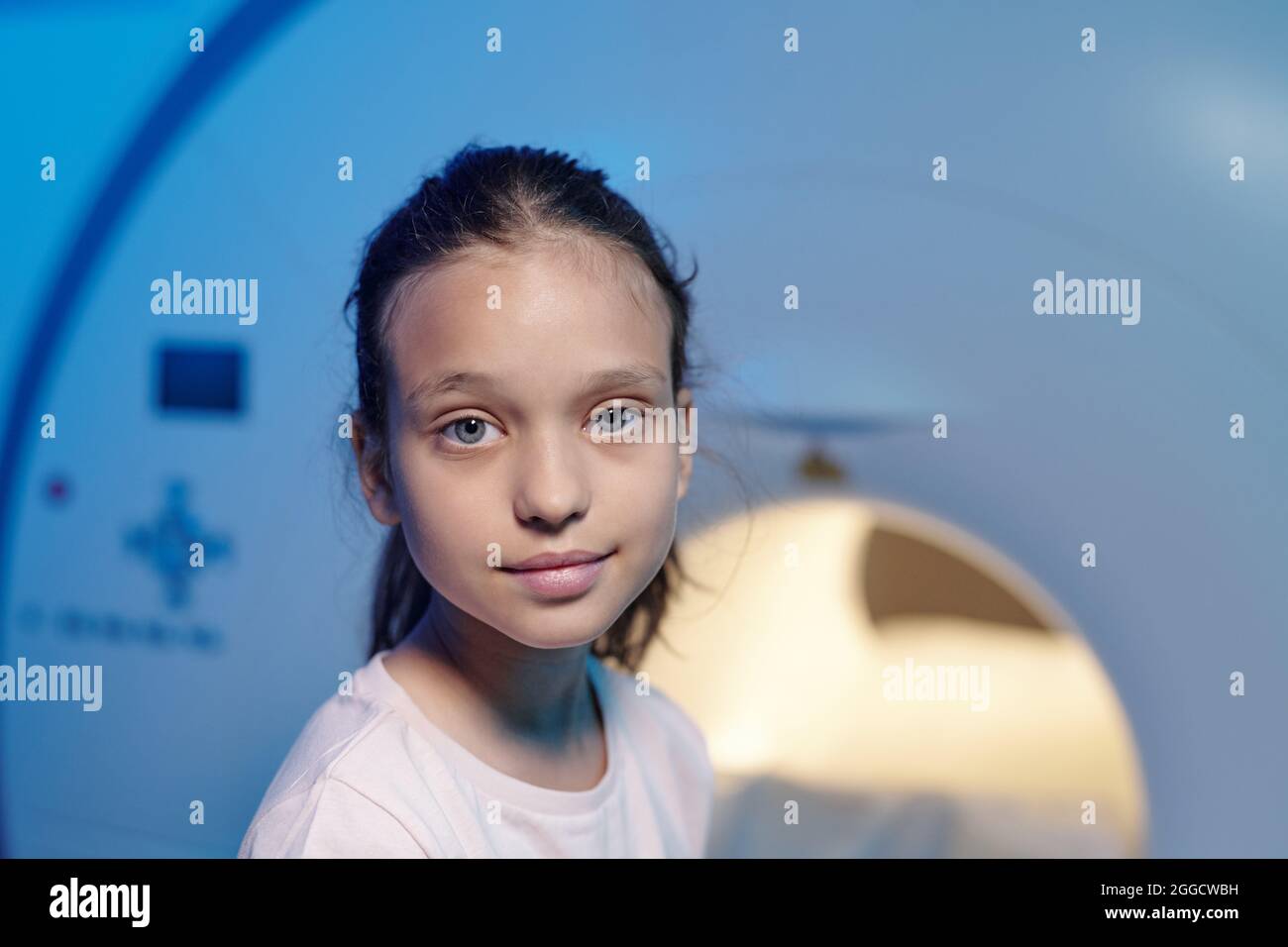 Face of cute little girl looking at you in medical laboratory before or ...