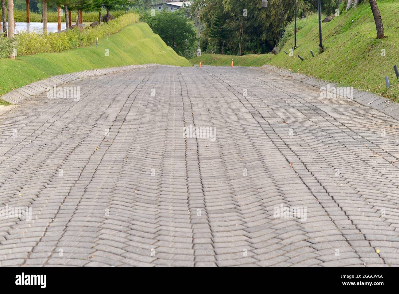 Brick path or sidewalk with perspective going into the distance with ...