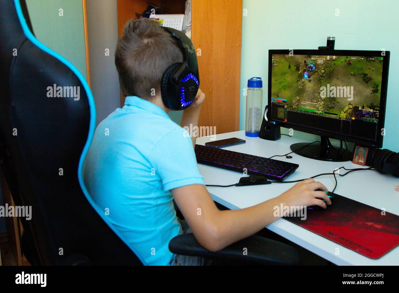 a boy plays in computer game Stock Photo - Alamy